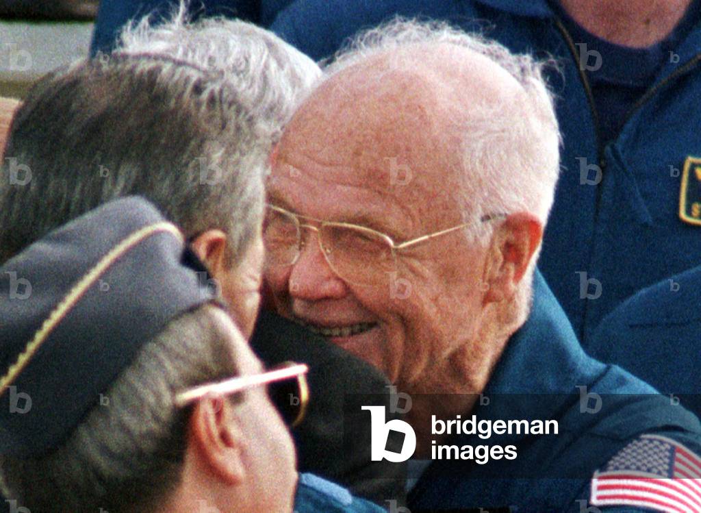 Image of Seventy-seven-year-old astronaut John Glenn gets a hug from ...