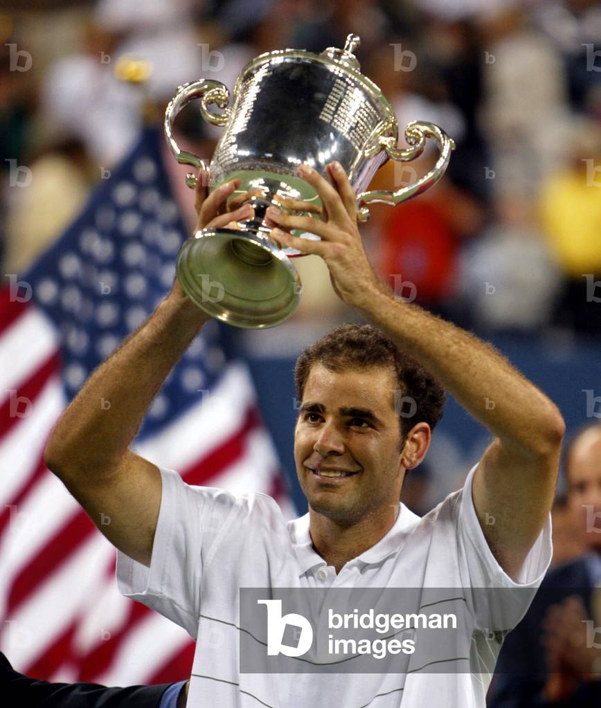 Image of Pete Sampras of the United States holds the trophy aloft