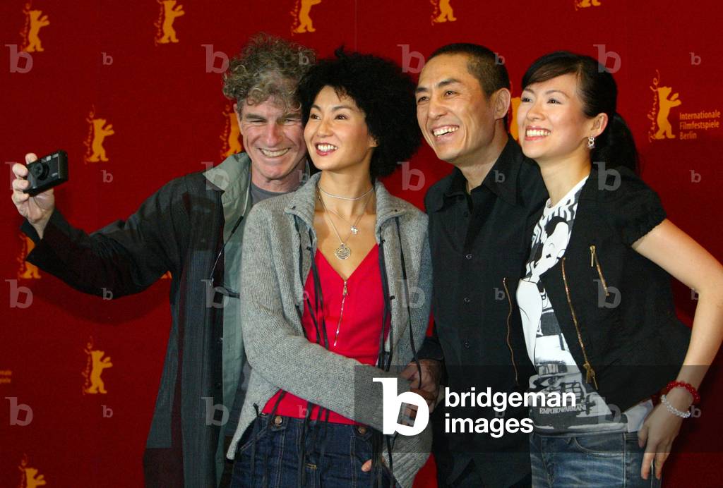 Image of ZHANG YIMOU SMILES WITH CHRISTOPHER DOYLE, MAGGIE CHEUNG AND ZHANG