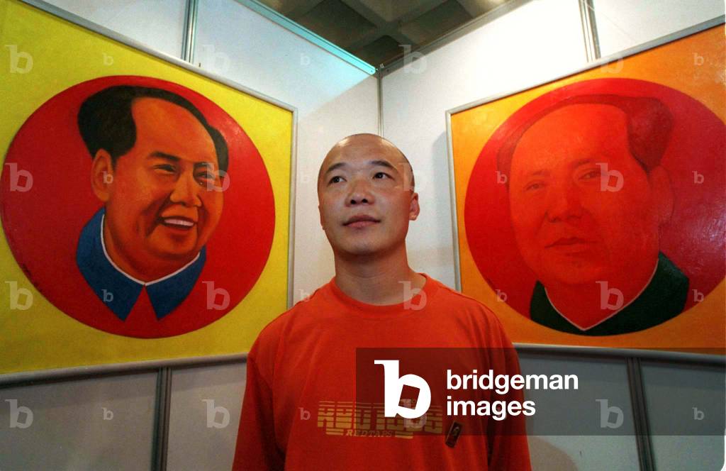 Image of Chinese artist Ma Yue poses with his art works, depicting by ...