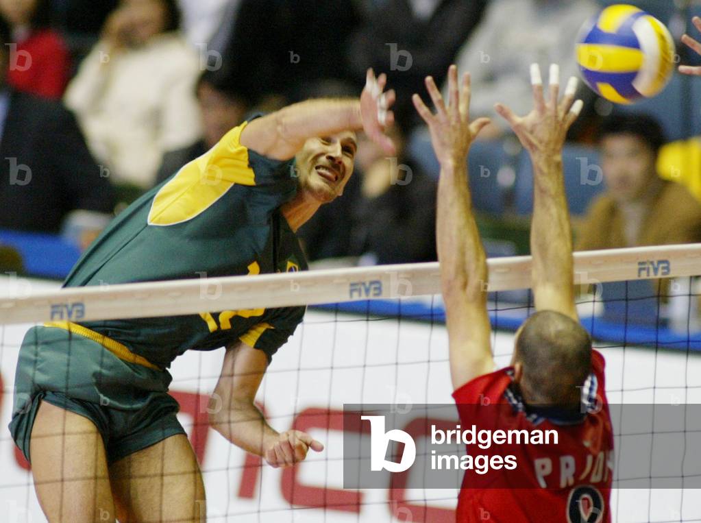 Image of BRAZILIAN CAPTAIN BITENCOURT SPIKES THE BALL OVER PRIDDY OF THE