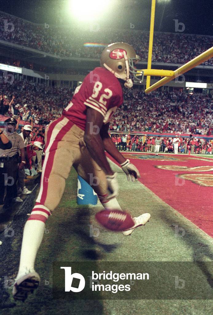 Image of SAN FRANCISCO 49ERS WIDE RECEIVER JOHN TAYLOR SPIKE THE FOOTBALL