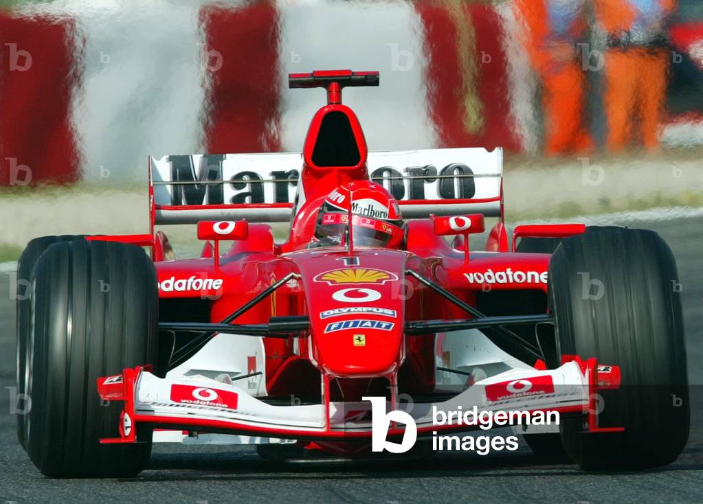 Image of GERMAN FORMULA ONE DRIVER MICHAEL SCHUMACHER TAKES A CURVE ...