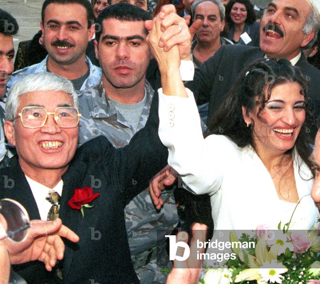 Image of Japanese Red Army guerrilla Massao Adachi (L) rises hands with