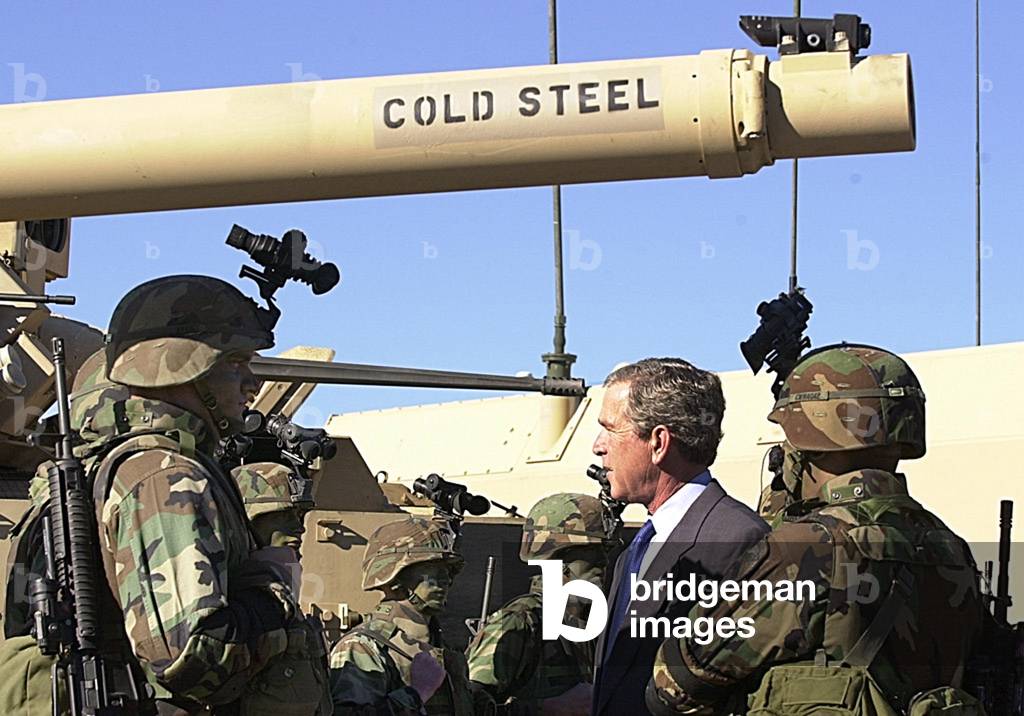 Image of US PRESIDENT BUSH WALKS UNDER BARREL OF ABRAMS TANK, 2003-01-03