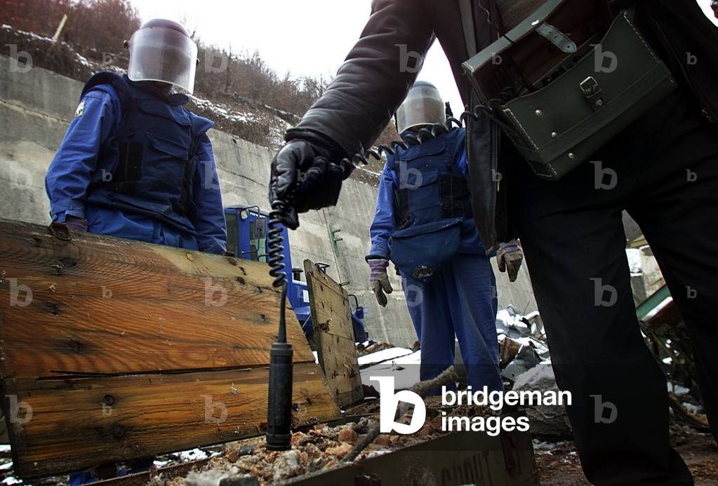 Image of A health expert measures radiation level as members of a