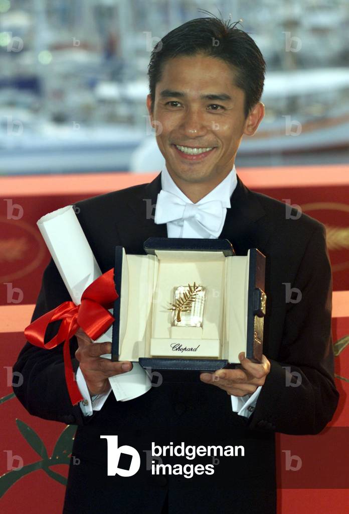 Image of Best Actor award winner Chinese actor Tony Leung Chiu-Wai holds