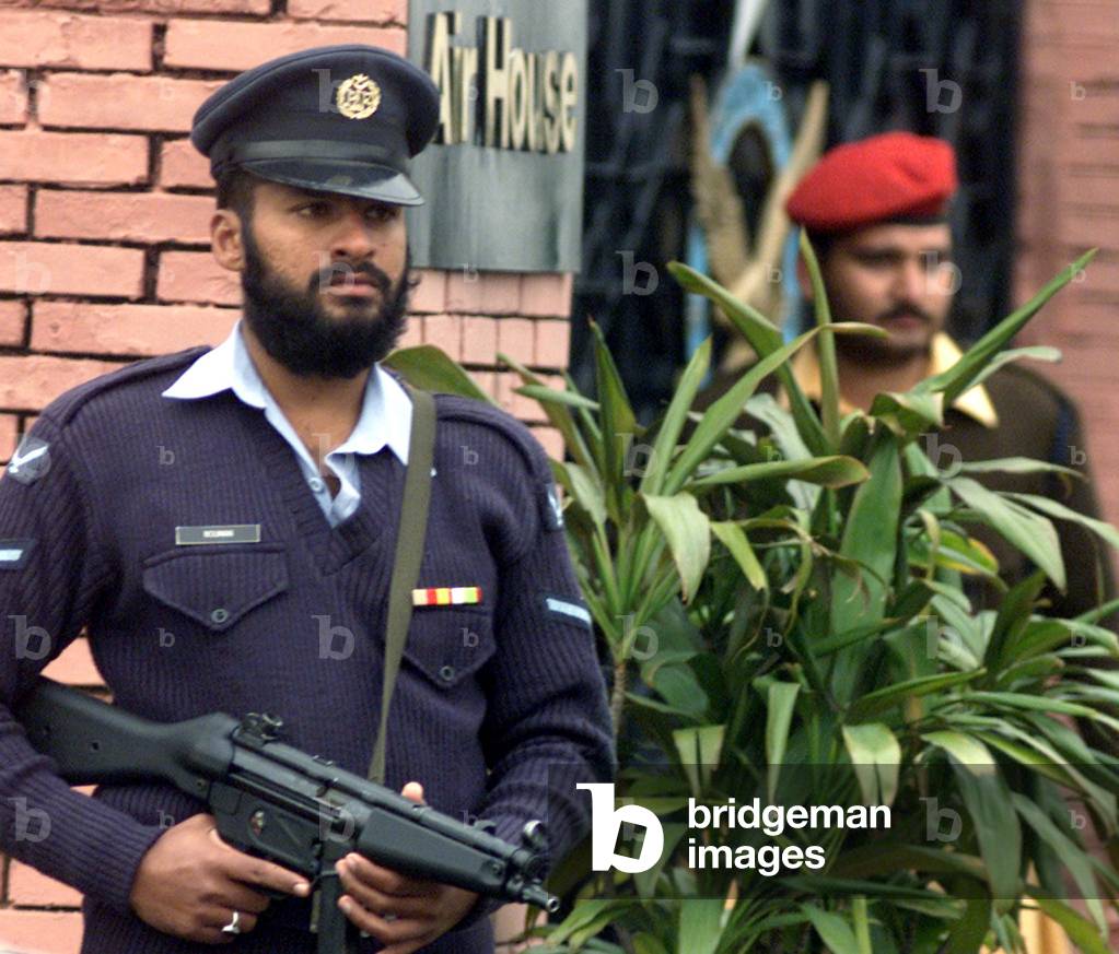Image of PAKISTANI ARMED AIR FORCE GUARD STANDS OUTSIDE THE RESIDENCE OF