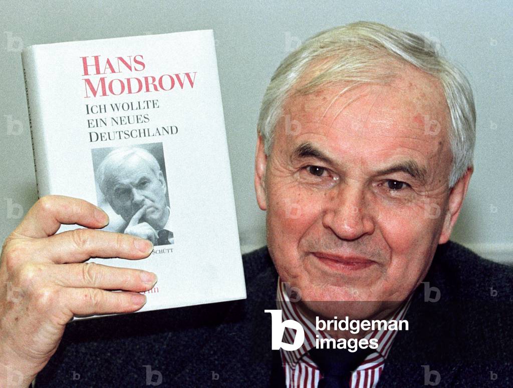 Image of Former East German Prime Minister Hans Modrow holds his new