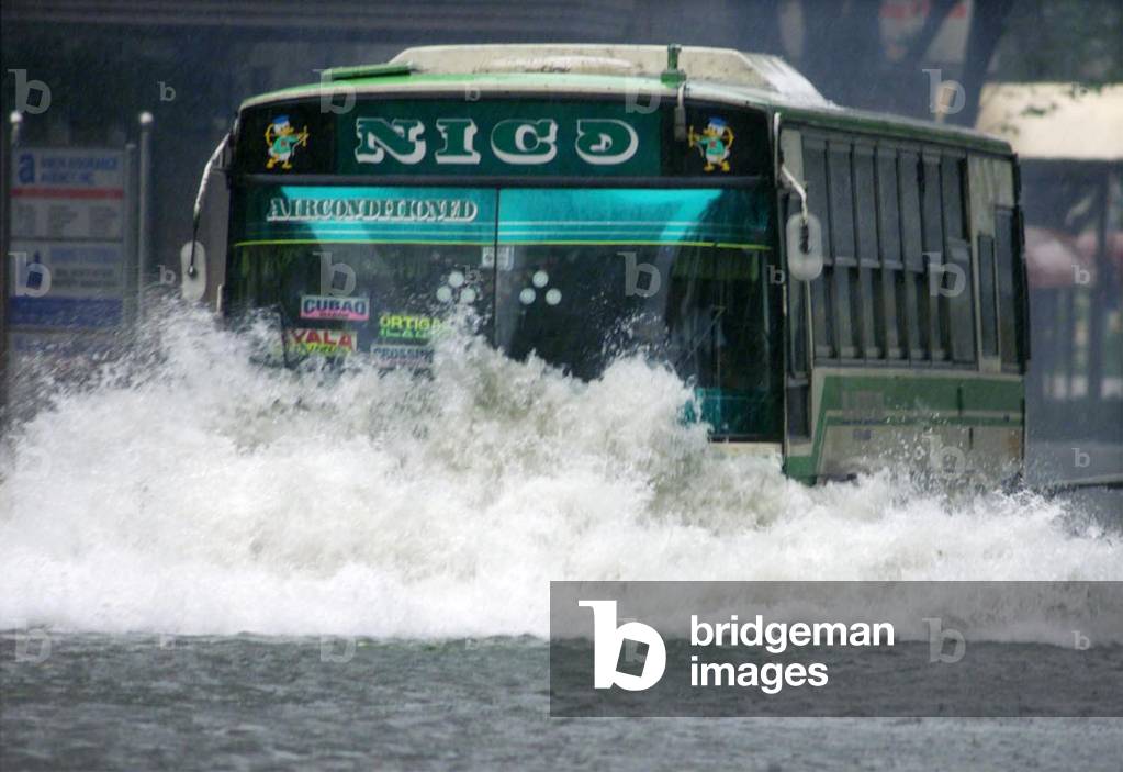 Image of A PASSENGER BUS DRIVES THROUGH FLOODWATERS IN MANILA, 2000-11 ...