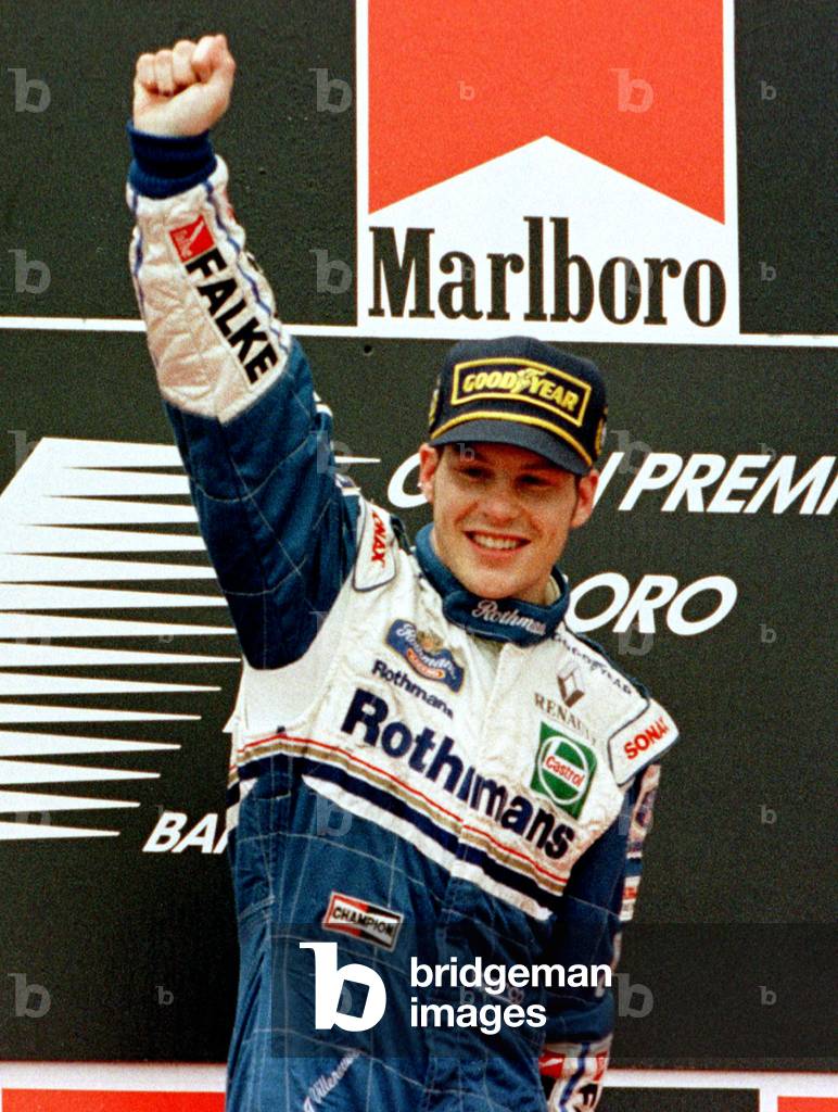 Image of Canadian Jacques Villeneuve salutes from the podium after ...