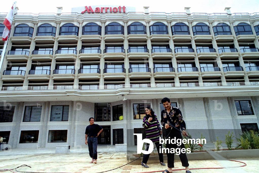 Image of Workers clean outside Beirut's Marriott hotel as the first guest