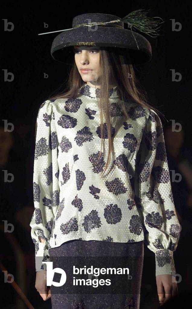 Image of A model displays an evening outfit as a part of