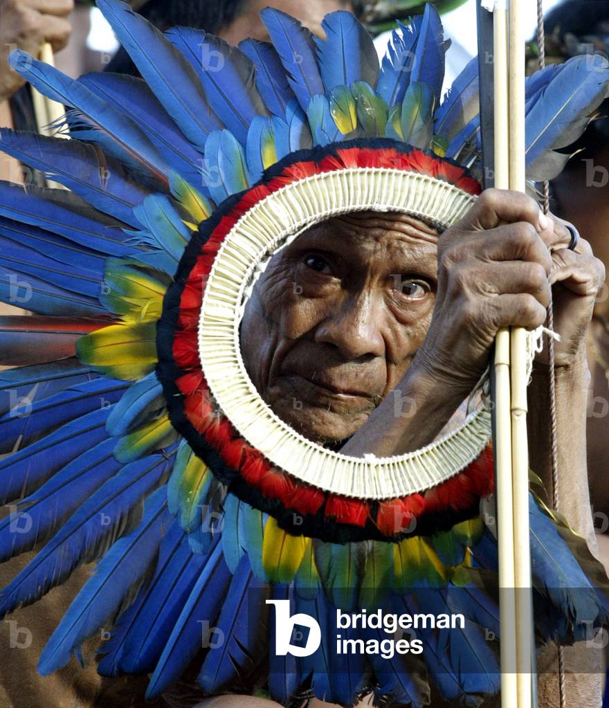 Image of An elderly indian from Brazil's Surui nation looks through a