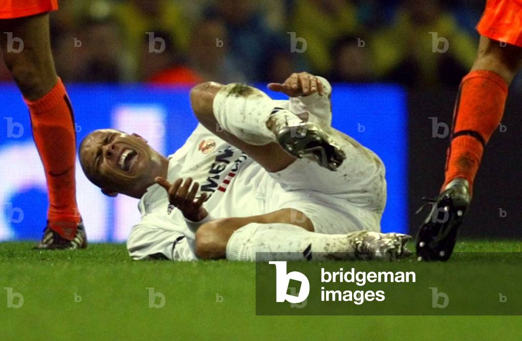 Image of REAL MADRID'S RONALDO GRIMACES IN PAIN AFTER BEING FOULED DURING
