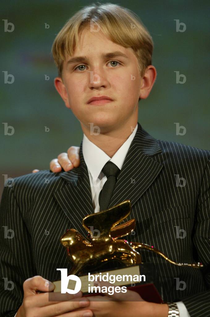 Image of RUSSIAN ACTOR IVAN DOBRONRAVOV HOLDS THE GOLDEN LION FOR THE
