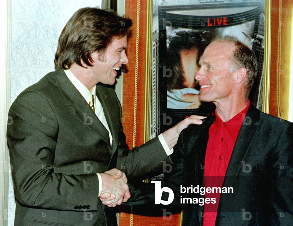 Image of Actor Jim Carrey (L), greets actor Ed Harris, who co-stars