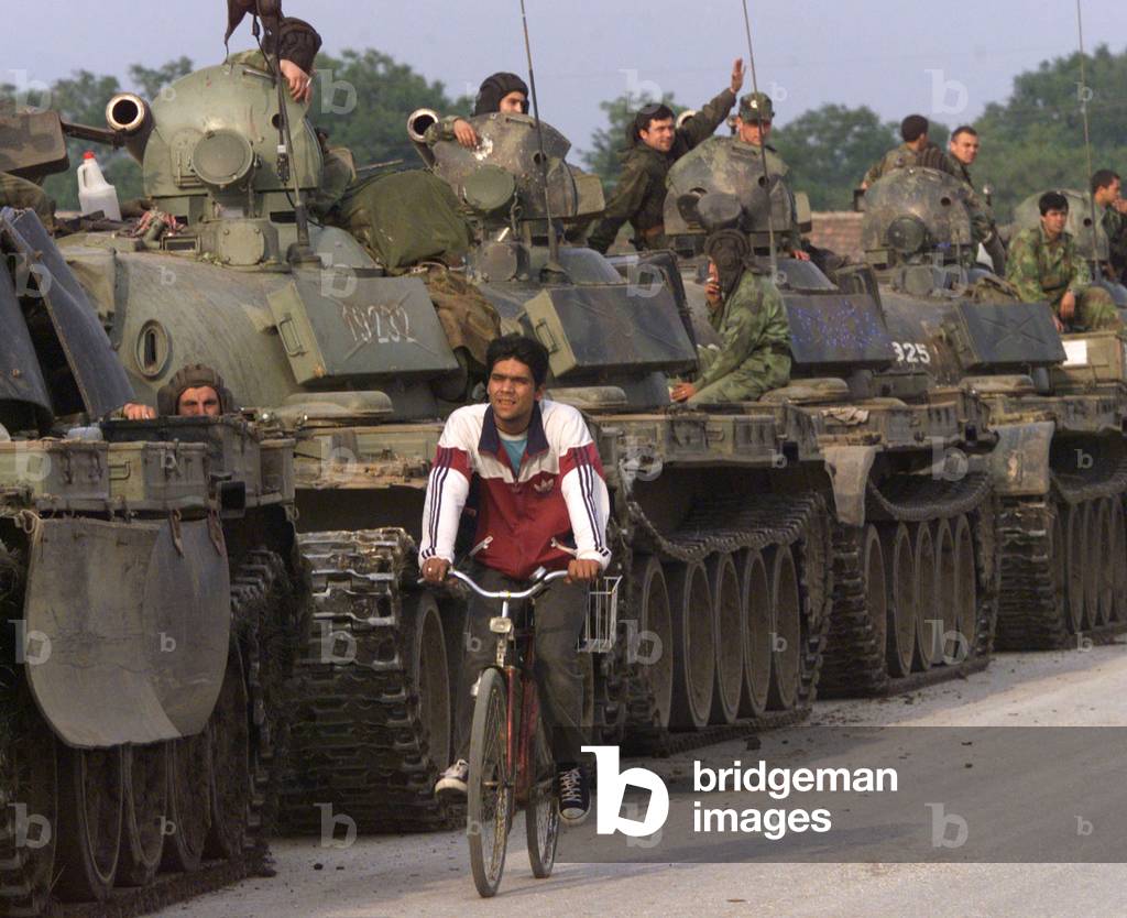 Image of A SERB TANKMAN WAVES ON THE ROAD IN KOSOVO POLJE,