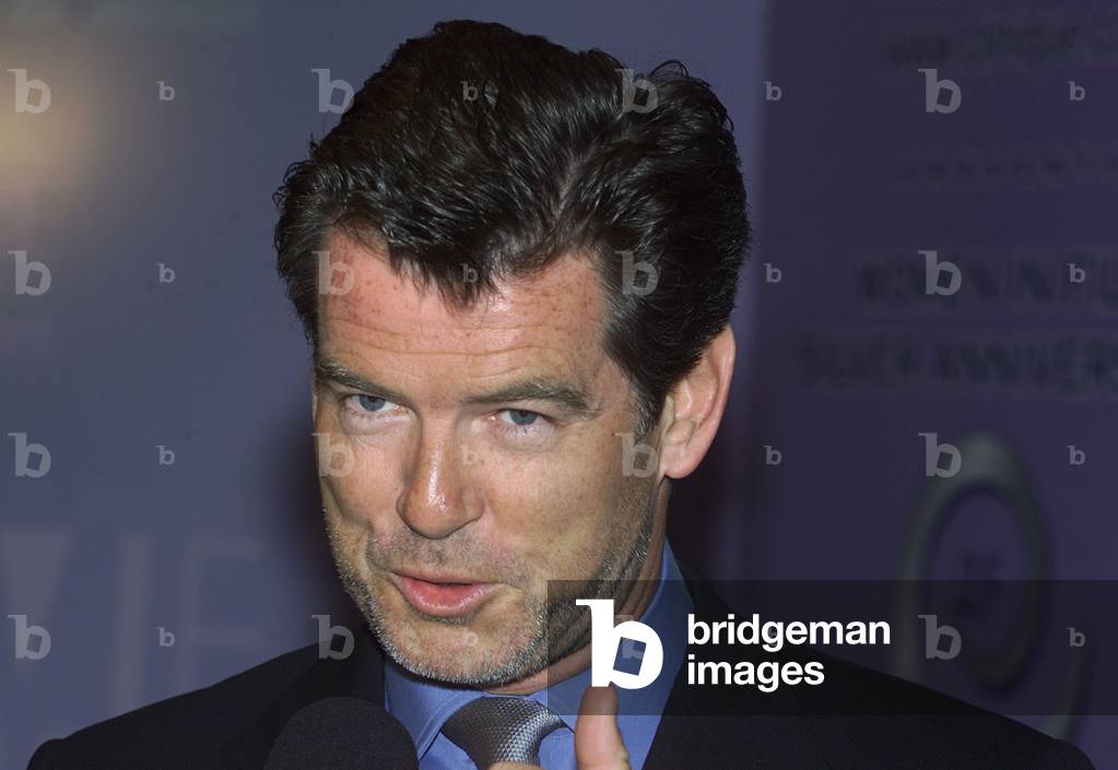 Image of Actor Pierce Brosnan poses for photographers as he arrives for