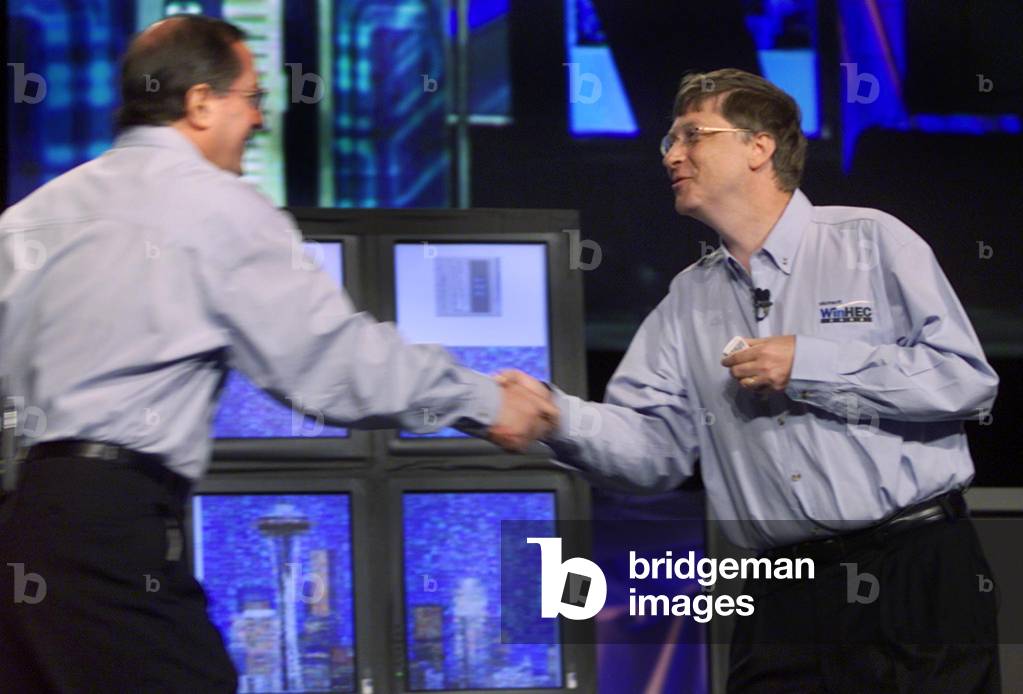 Image of MICROSOFTS BILL GATES AND INTELS PAUL OTELLINI SHAKE HANDS AT