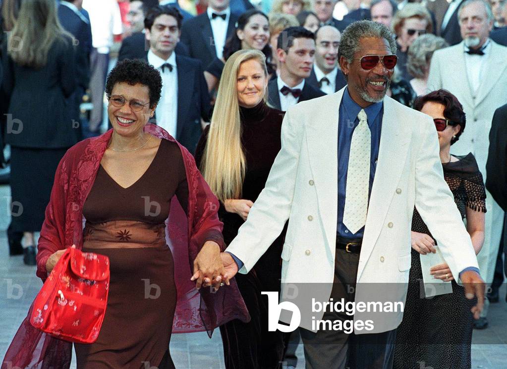 Image of US actor Morgan Freeman (R) holds hands with his wife