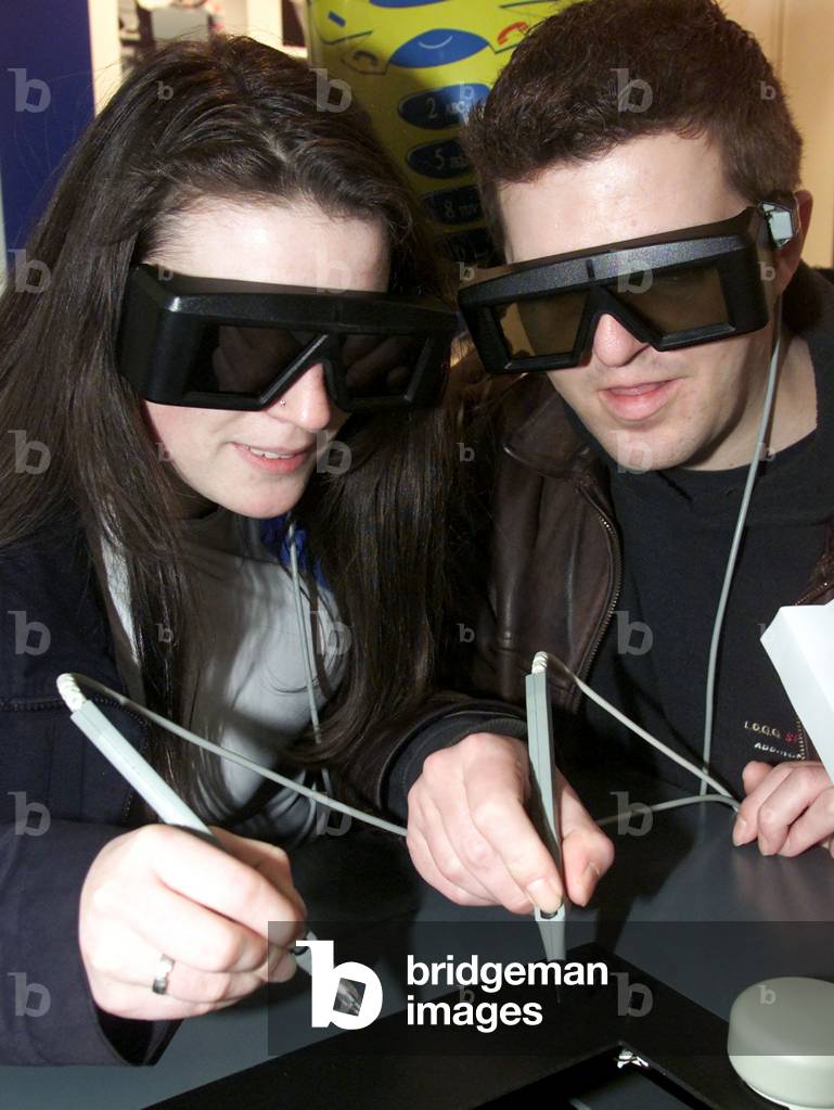 Image of Two visitors of the CeBIT computer fair use the "Illusion