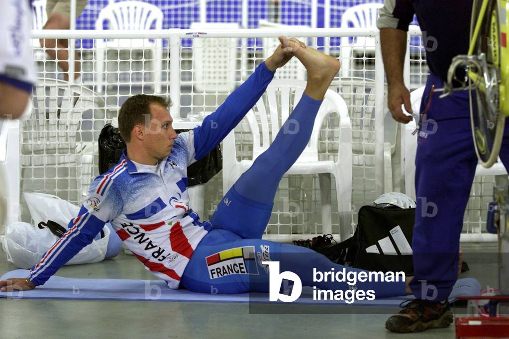 Image of CYCLIST FLORIAN ROUSSEAU OF FRANCE STRETCHES TO WARM UP AT