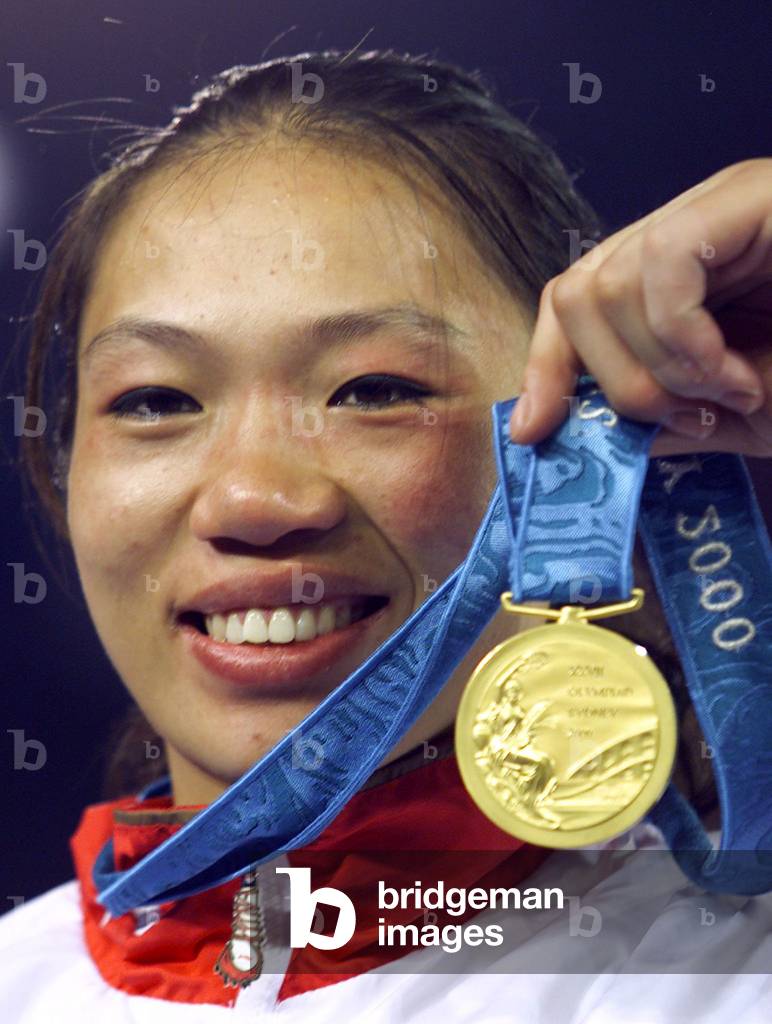 Image of Tang Lin of China displays her Olympic gold medal on
