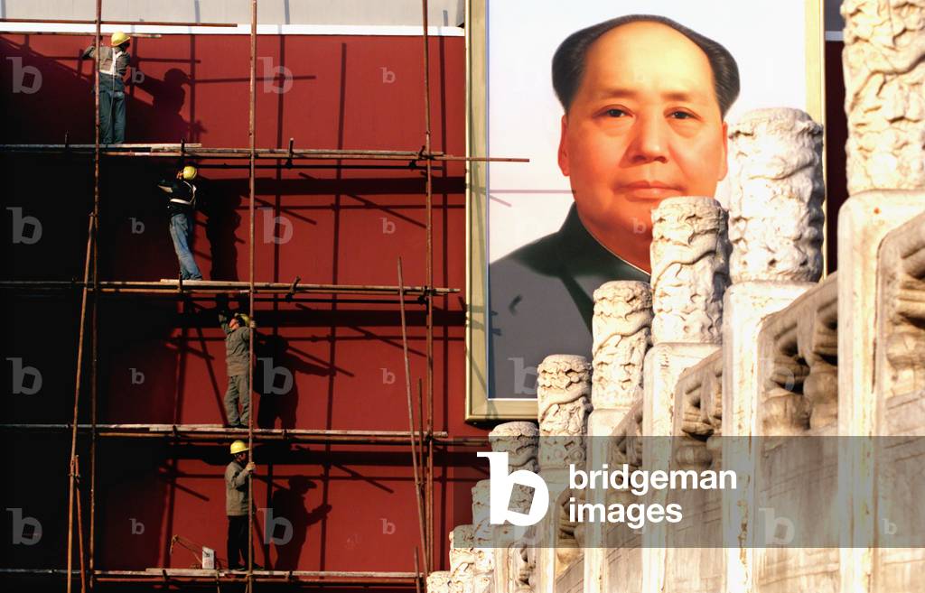 Image of CHINESE WORK NEXT TO PORTRAIT OF THE LATE CHAIRMAN MAO