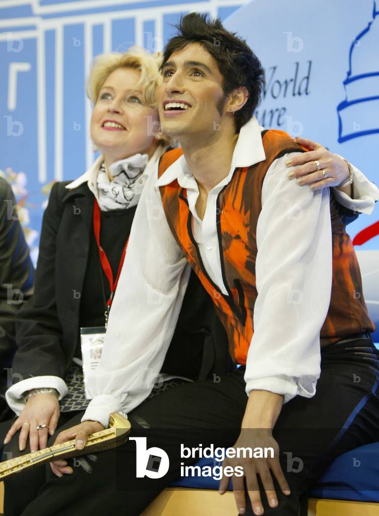Image of SANDHU OF CANADA WITH HIS COACH AFTER SKATING IN THE