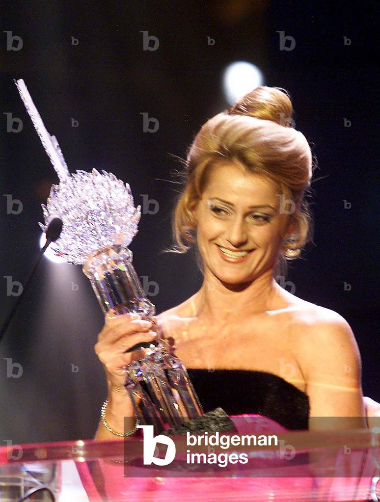 Image of Gymnastics legend Nadia Comaneci holds up the trophy in Vienna's