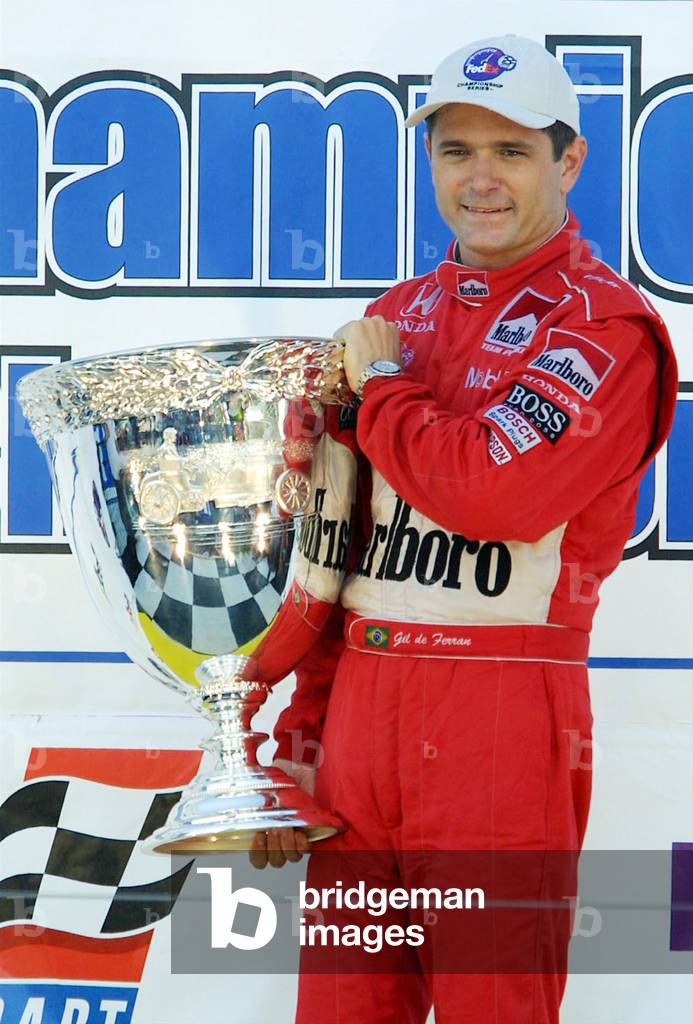 Image of BRAZILIAN GIL DE FERRAN HOLDS THE TROPHY AFTER CLINCHING THE
