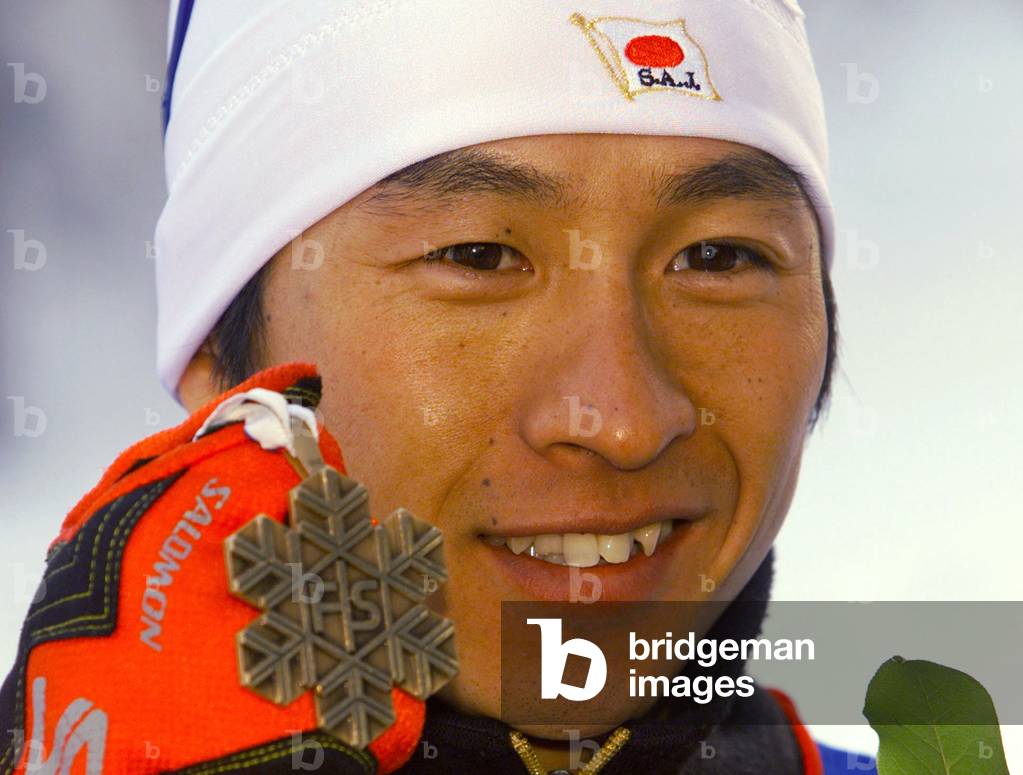 Image of Kenji Ogiwara of Japan displays his bronze medal he won