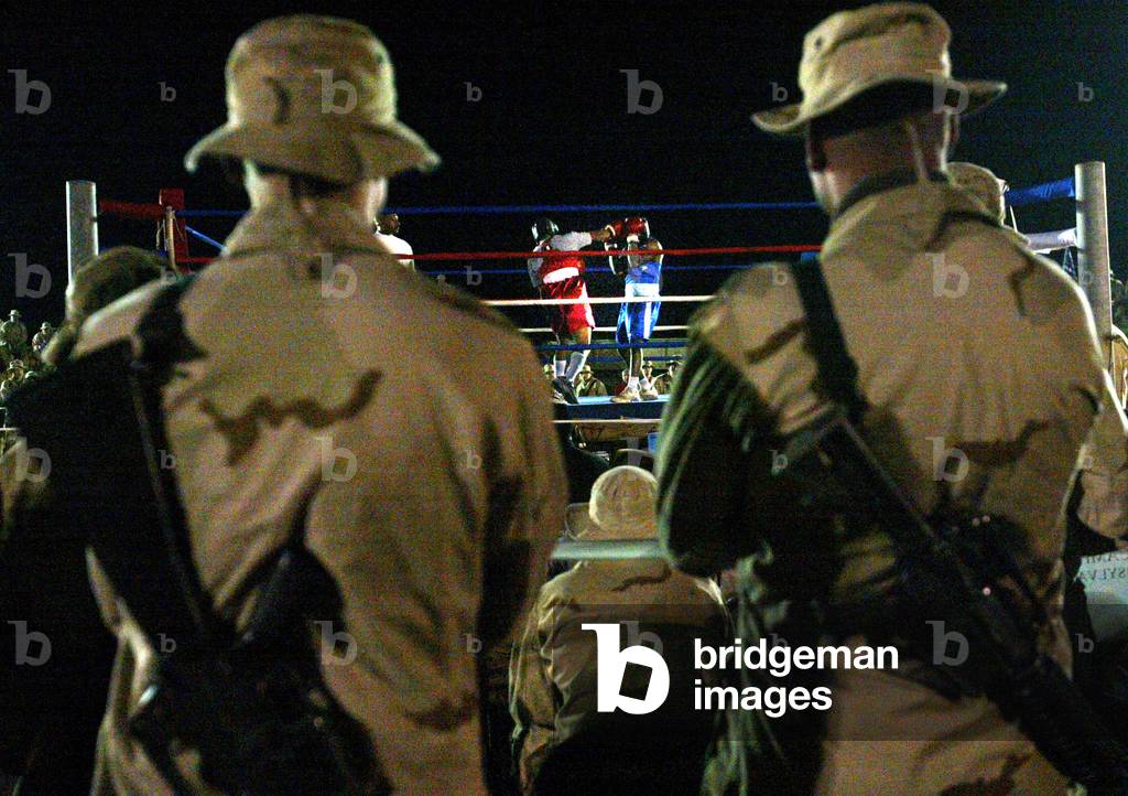 Image of United States Army soldiers watch a boxing match at Camp