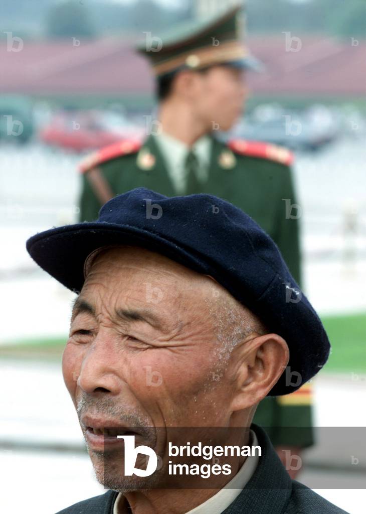 Image of CHINESE MAN POSES FOR A PHOTO IN TIANANMEN SQUARE, 2000-09-26