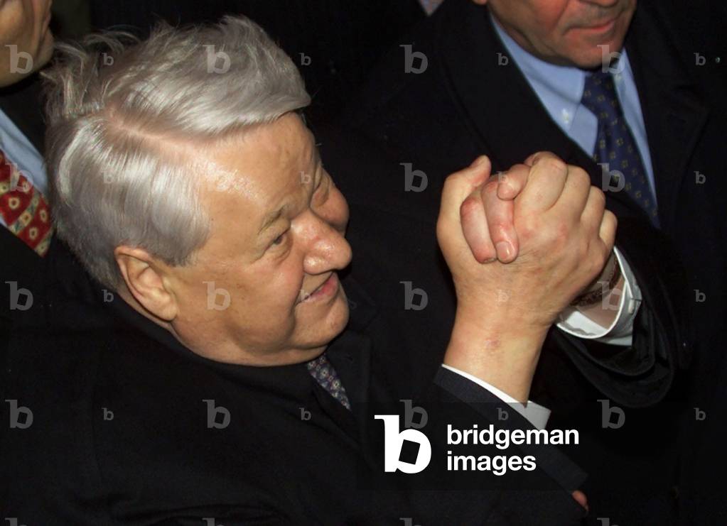 Image of Former Russian President Boris Yeltsin clasps his hands and gives