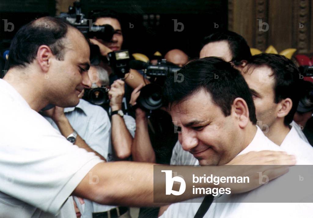 Image of GREEK AND TURKISH CYPRIOT FAMILY CONSOLE EACH OTHER AT BURIAL