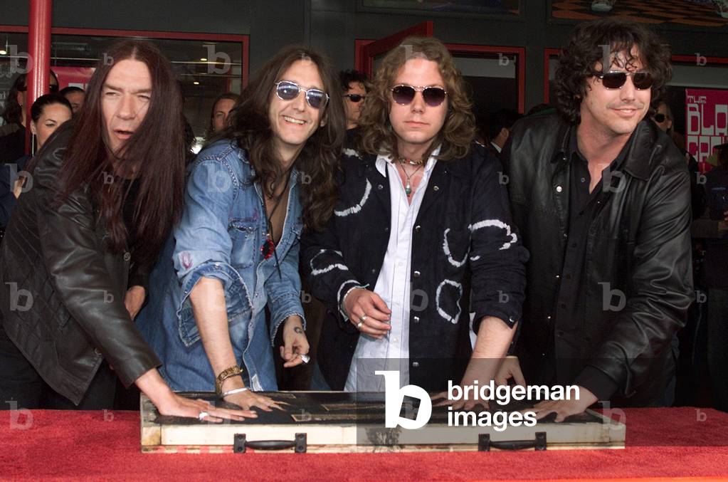 Image of Members of the rock group The Black Crowes place their