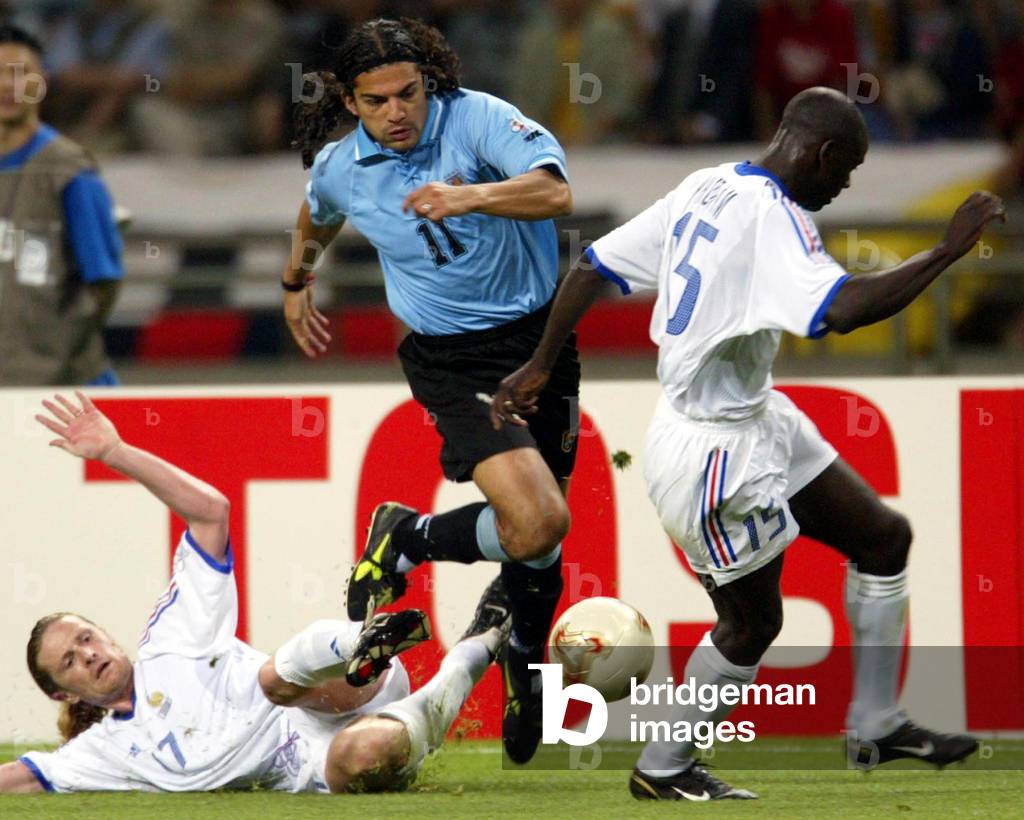Image of France's Emmanuel Petit (L) tackles Uruguay's Federico ...
