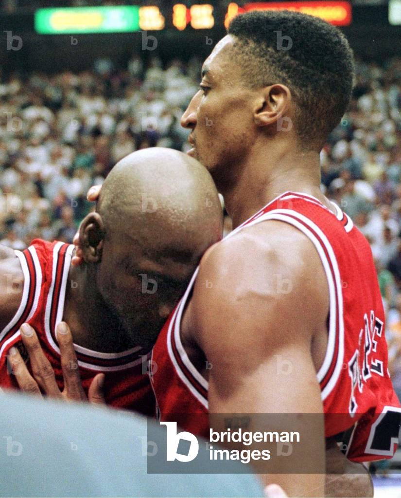 Image of MICHAEL JORDAN LEANS HEAD INTO TEAMMATE PIPPEN AFTER NBA WIN,