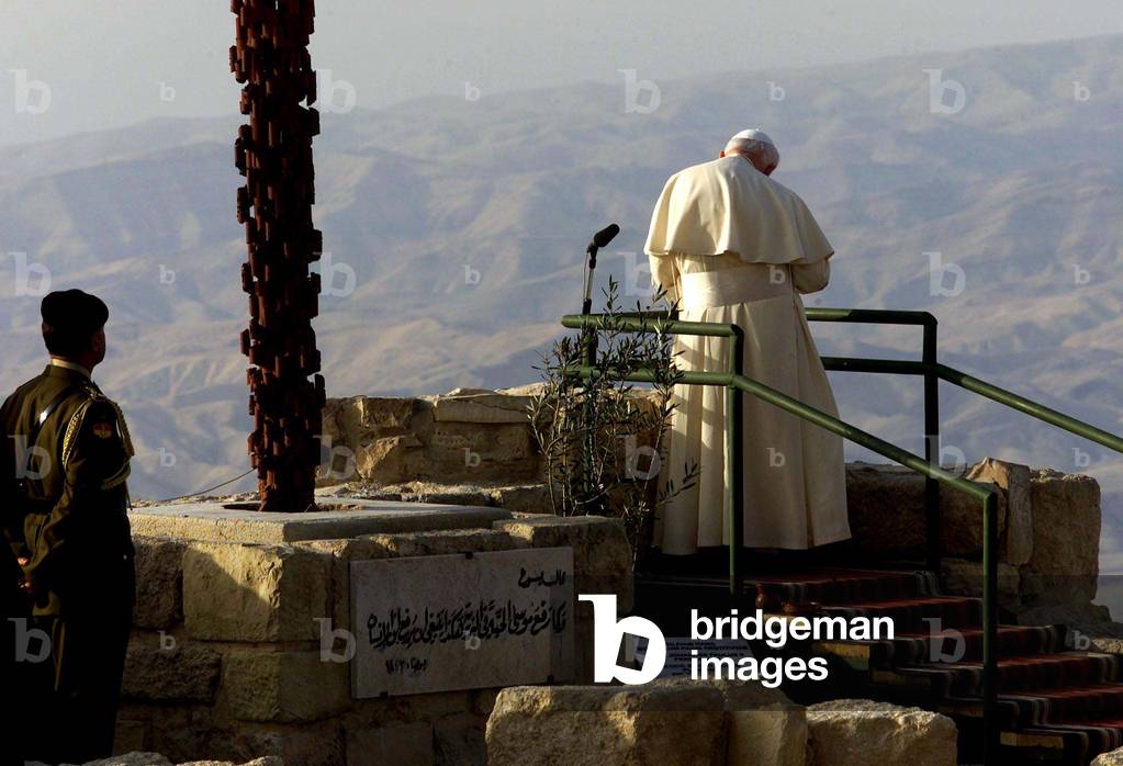 Image of POPE JOHN PAUL II PRAYS BENEATH THE CROSS OF THE