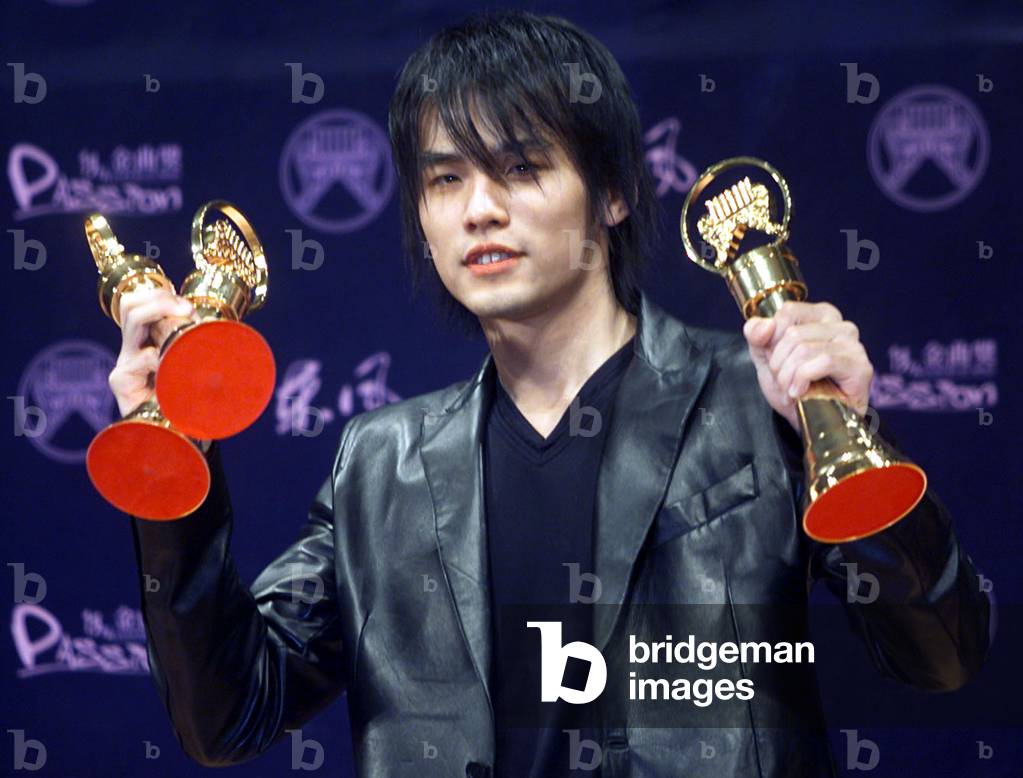 Image of TAIWAN SINGER JAY CHOU POSES HIS AWARDS DURING THE GOLDEN