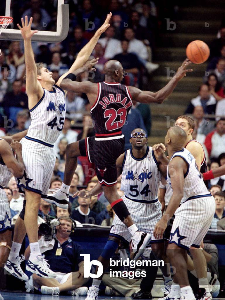 Image of Chicago Bulls guard Michael Jordan goes high to the basket