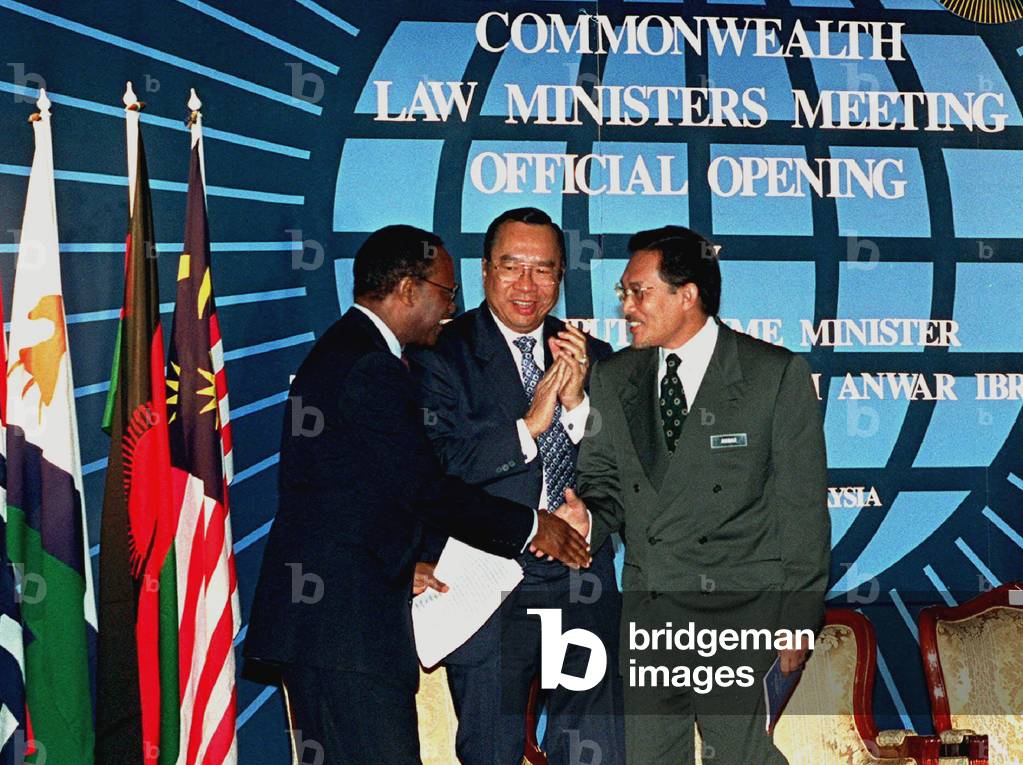 Image of Malaysian Deputy Prime Minister Anwar Ibrahim (R) shakes hand with