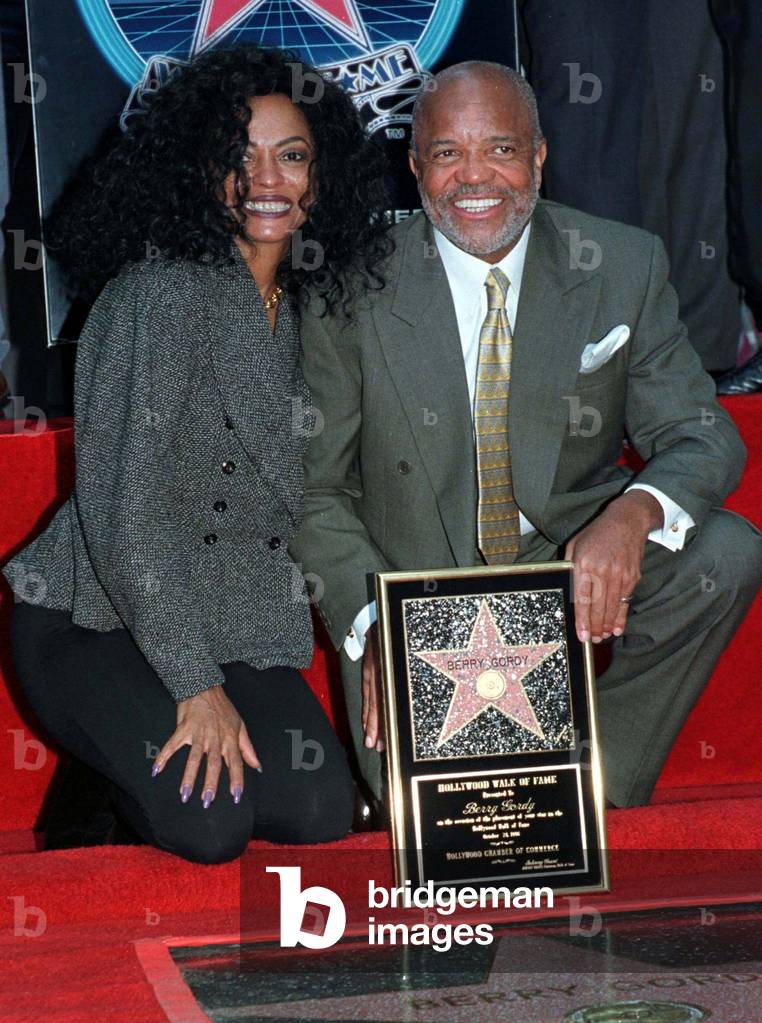 Image of Motown Records founder Berry Gordy (R) poses with singer and