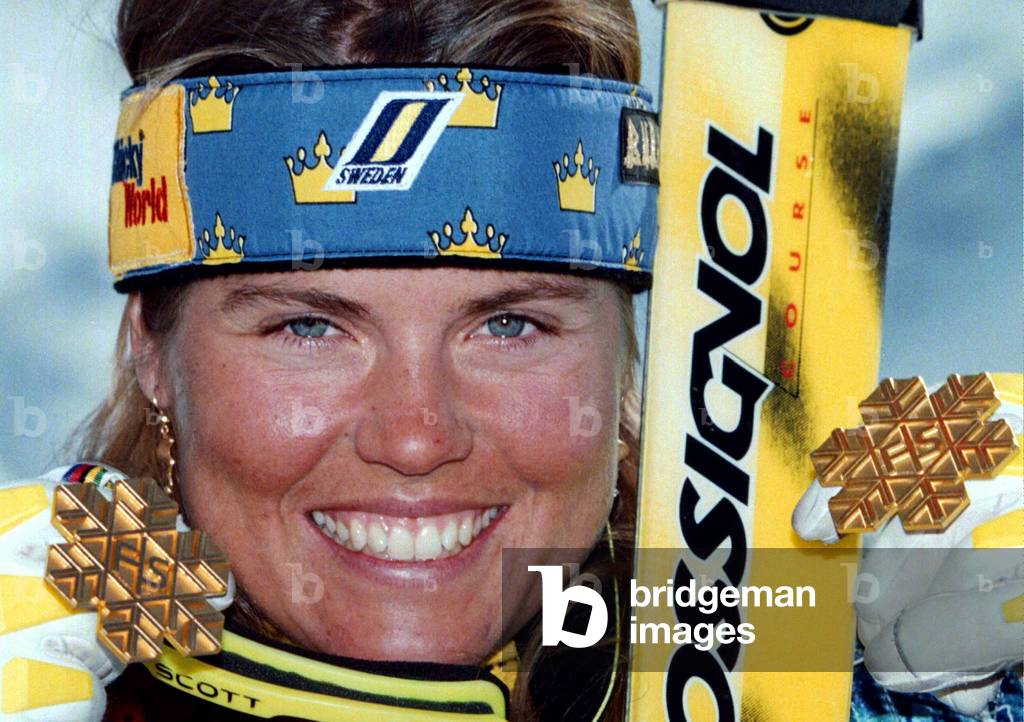 Image of Sweden's Pernilla Wiberg smiles as she shows her two gold