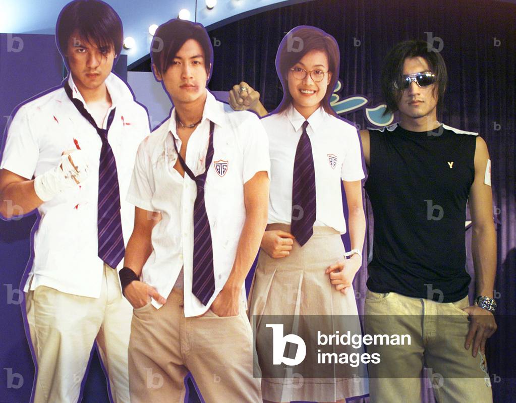 Image of HONG KONG'S NICHOLAS TSE POSES BESIDE PORTRAITS OF CHARACTERS IN