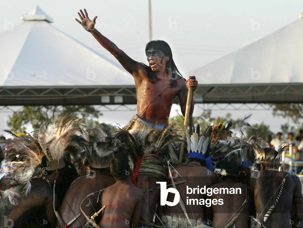 Image of A leader from Brazil's Xerente nation parades atop some of
