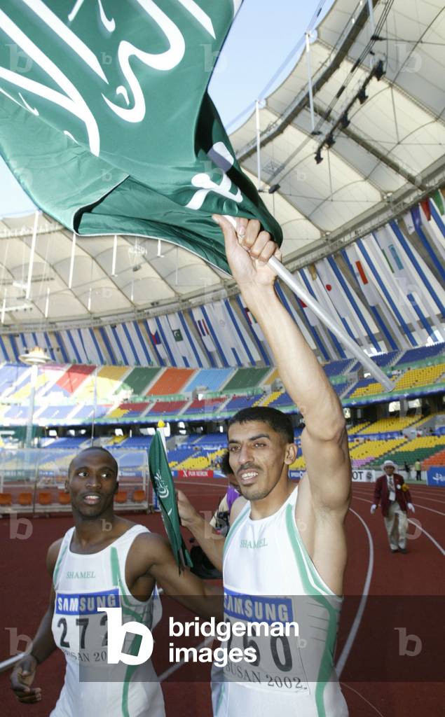 Image of SAUDI ARABIA'S AL SAFAAR WAVES HIS NATION'S FLAG AFTER WINNING