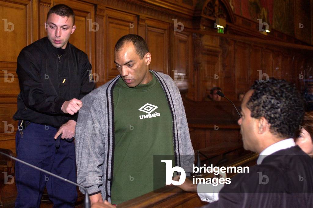 Image of Accused French serial killer Guy Georges (R) is lead into